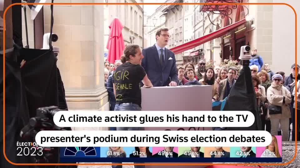 Climate protester glues hand to podium during Swiss TV debate | Reuters
