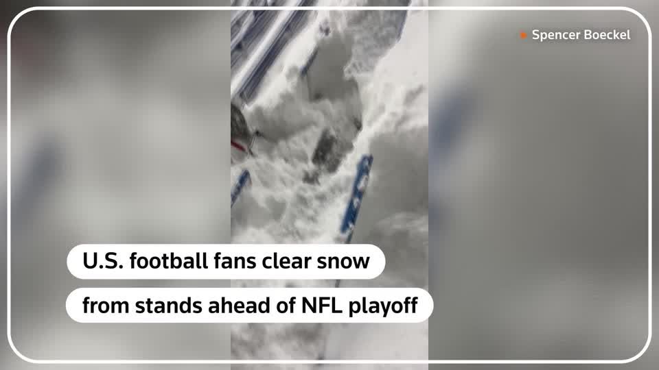 U.S. football fans clear snow from stadium seats | Reuters