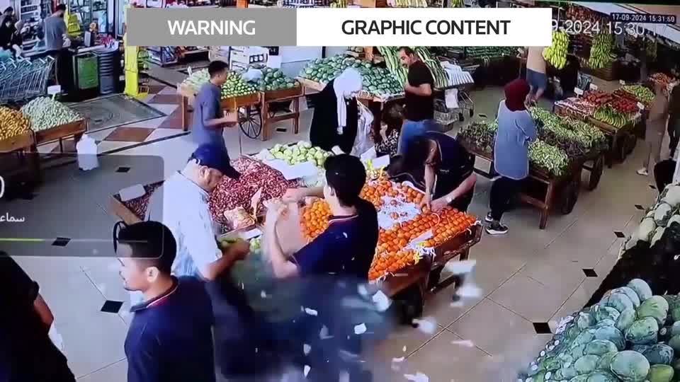 CCTV captures moment man's bag explodes in Beirut | Reuters