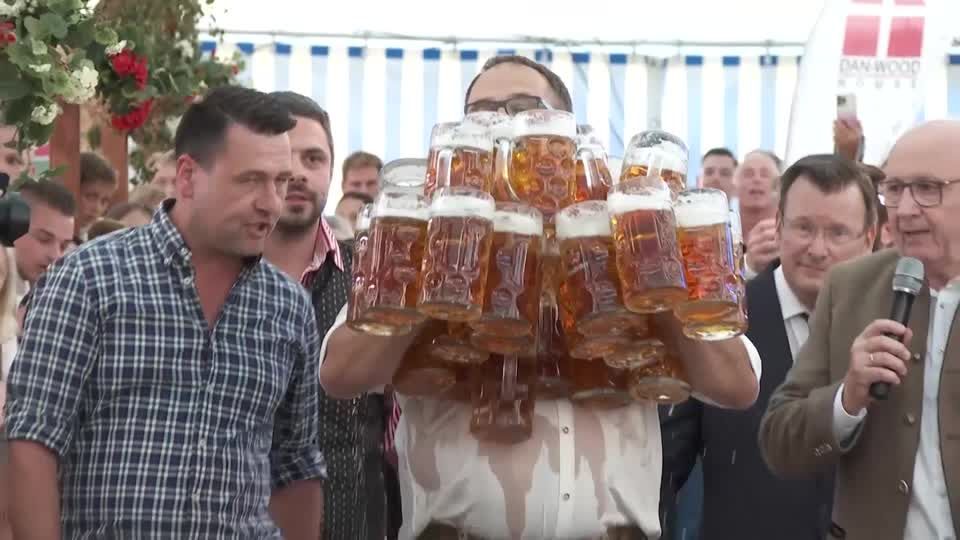 Oops! Attempt to break beer-mug carry record falls short | Reuters