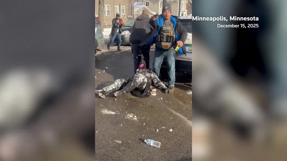 Video shows ICE agent dragging woman through Minneapolis street | Reuters
