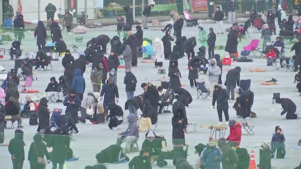 Visitors brave winter cold at ice fishing festival in South Korea | Reuters