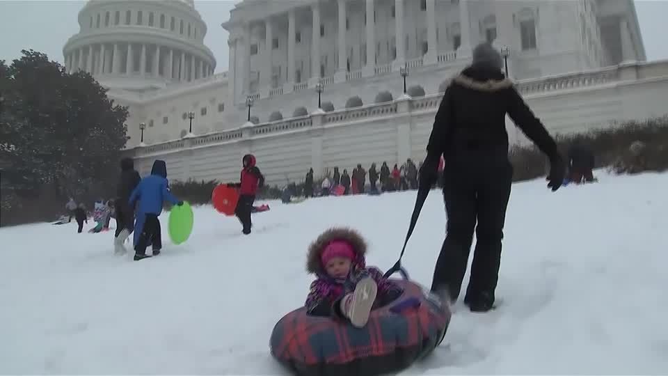 Children sled near the U.S. Capitol as massive winter storm rolls on ...